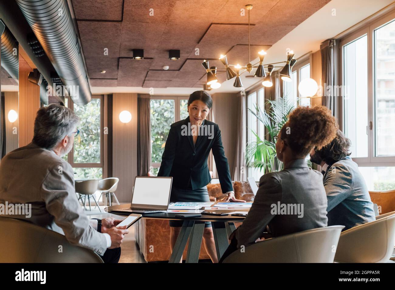 Italy, Business people having meeting in creative studio Stock Photo ...