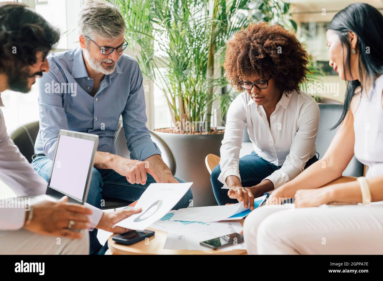 Italy, Business people having meeting in creative studio Stock Photo ...