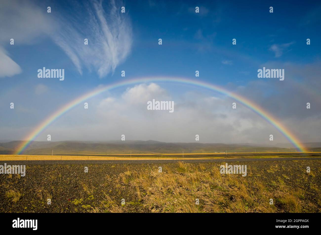Iceland, Rainbow above highway in landscape Stock Photo - Alamy