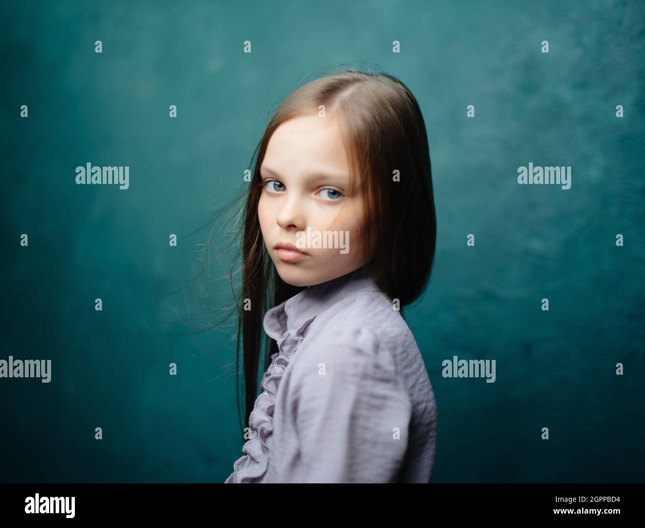 Girl in dress long hair studio green background close-up Stock Photo - Alamy