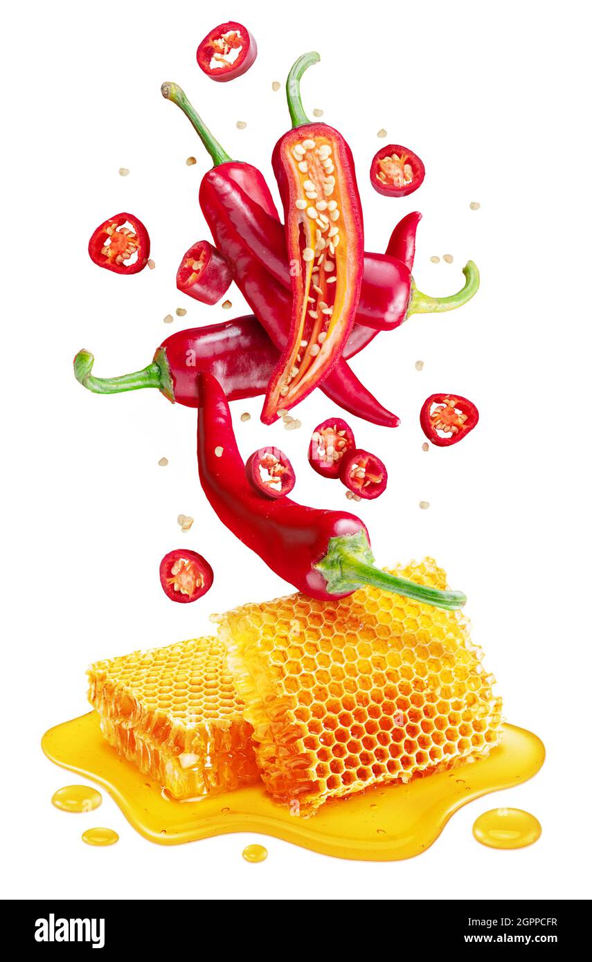 Fresh red chilli pepper and sections of chilli pepper floating over ...