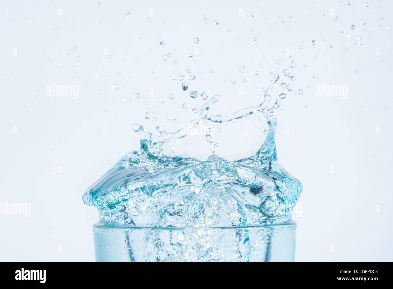 water splash in a glass white background Stock Photo - Alamy