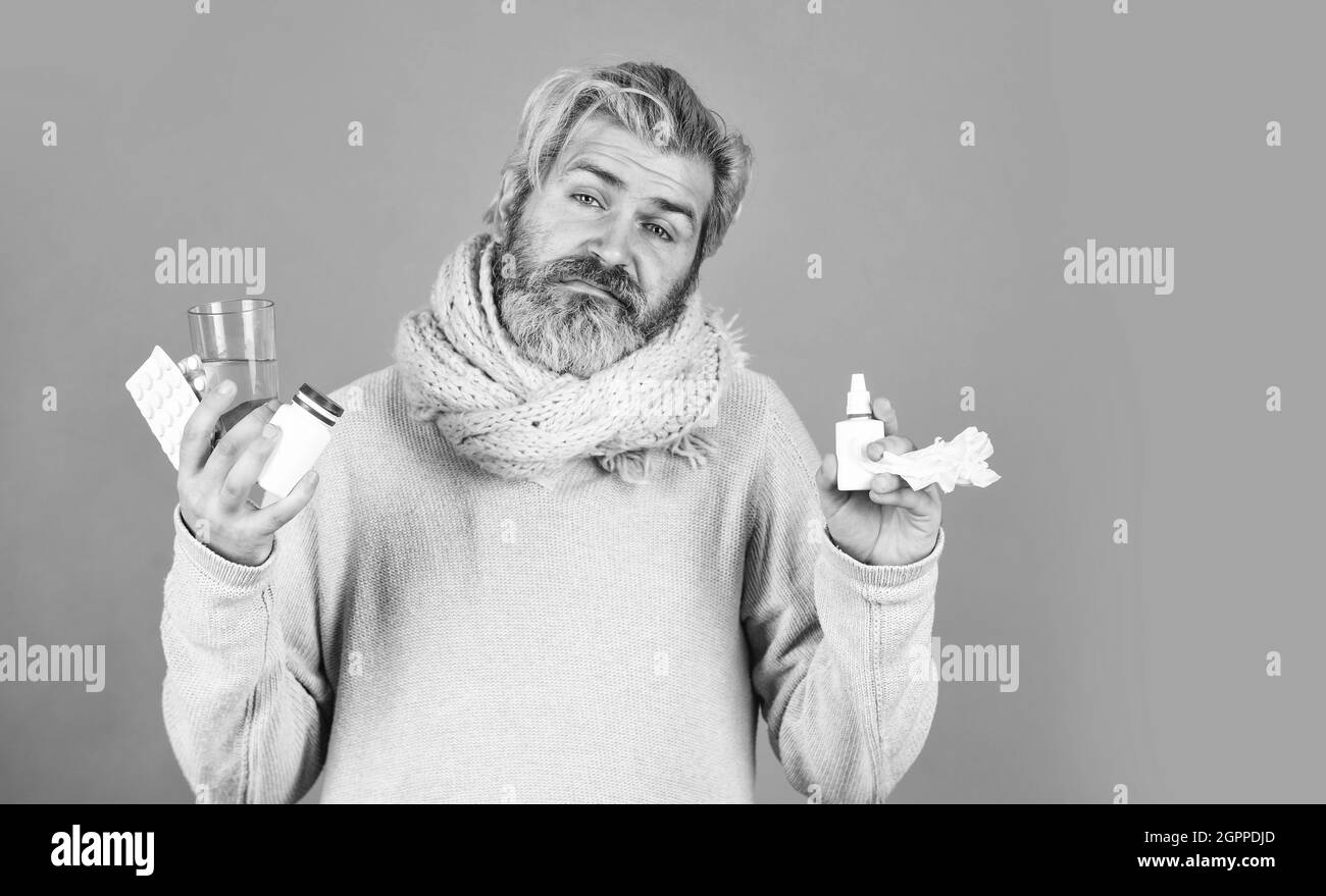 How to bring fever down. man ready to take a pill. ill man at home ...