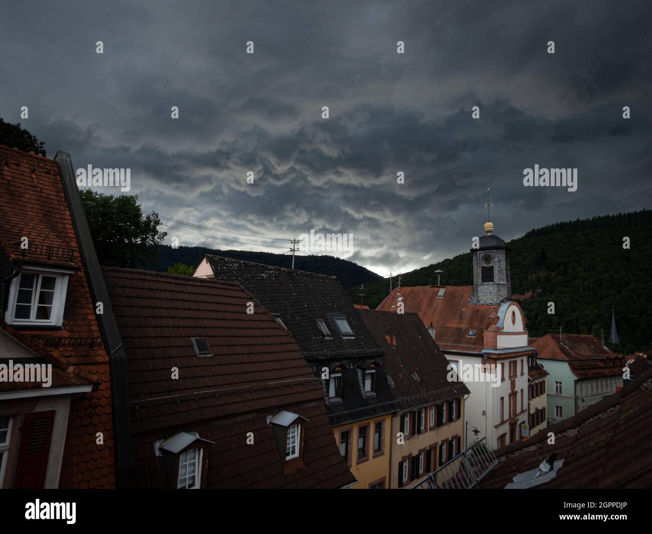 dramatic storm clouds just before a heavy rain over a small town in ...