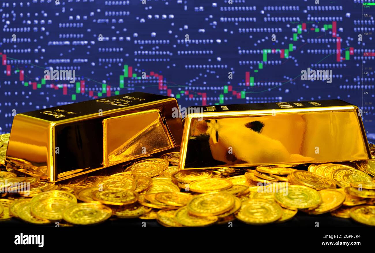 Gold bullion on at computer trading chart background Stock Photo - Alamy