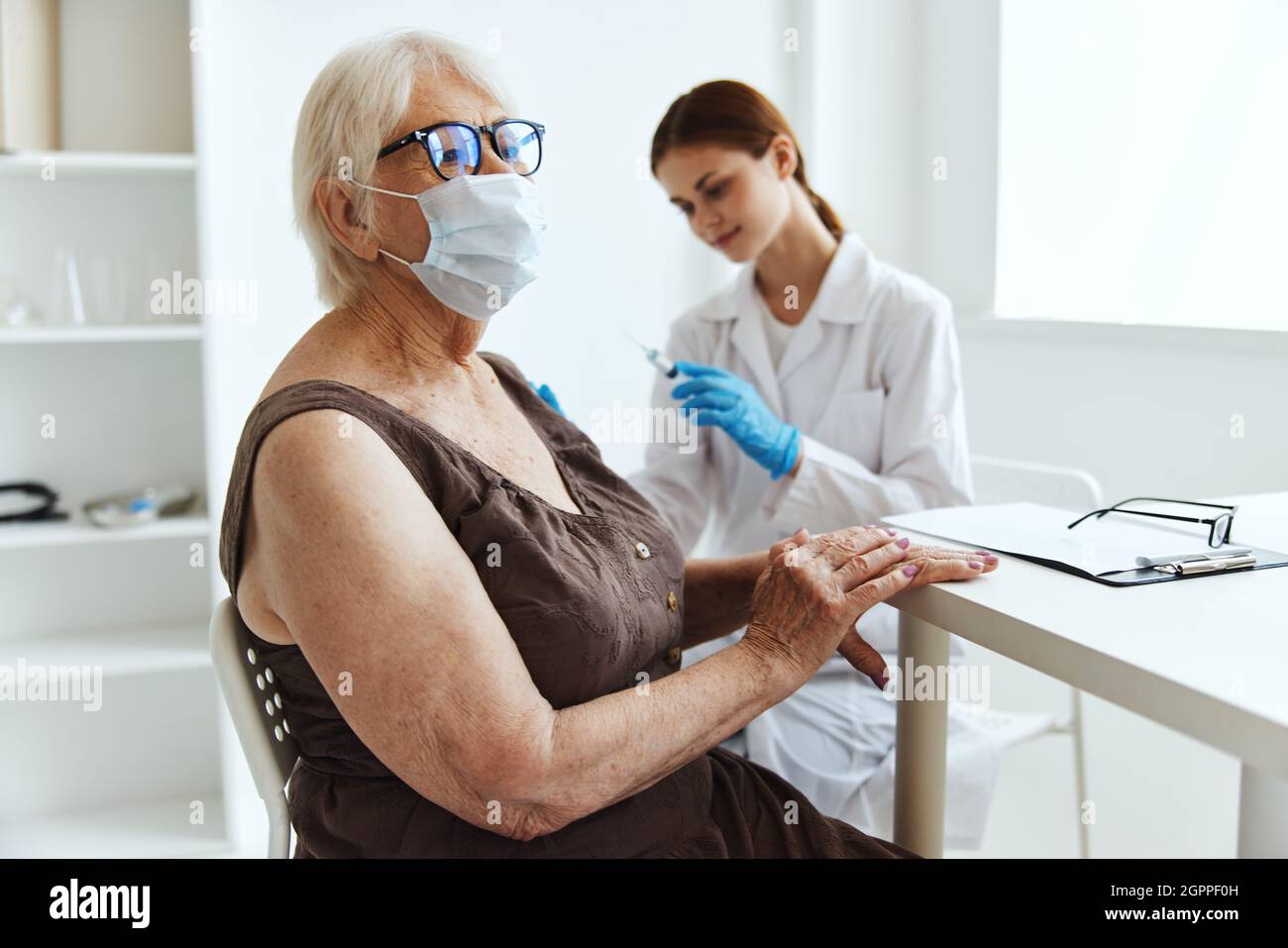 elderly woman wearing a medical mask syringe injection vaccine passport ...