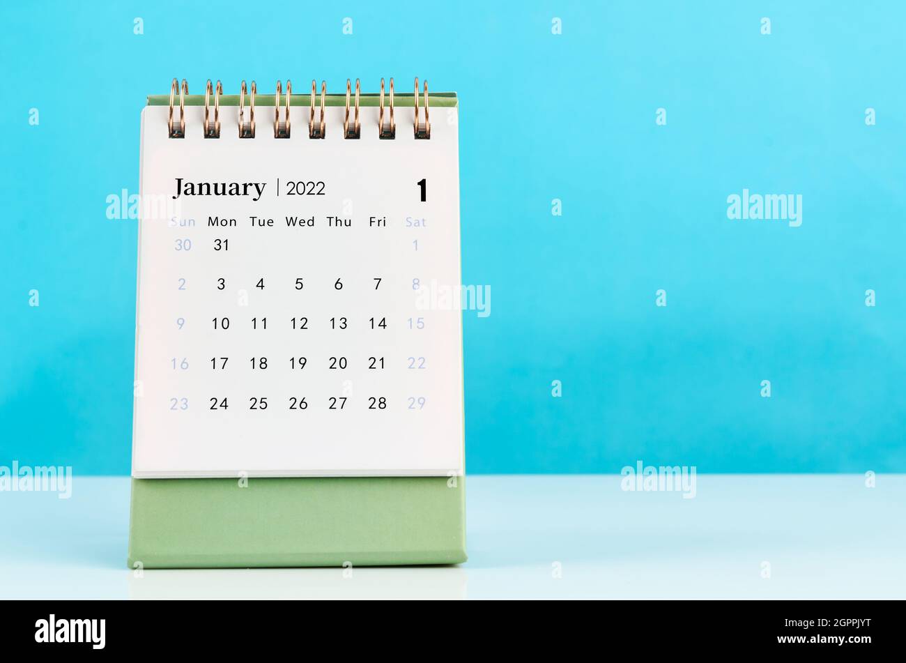 January 2022 desk calendar on blue background Stock Photo - Alamy