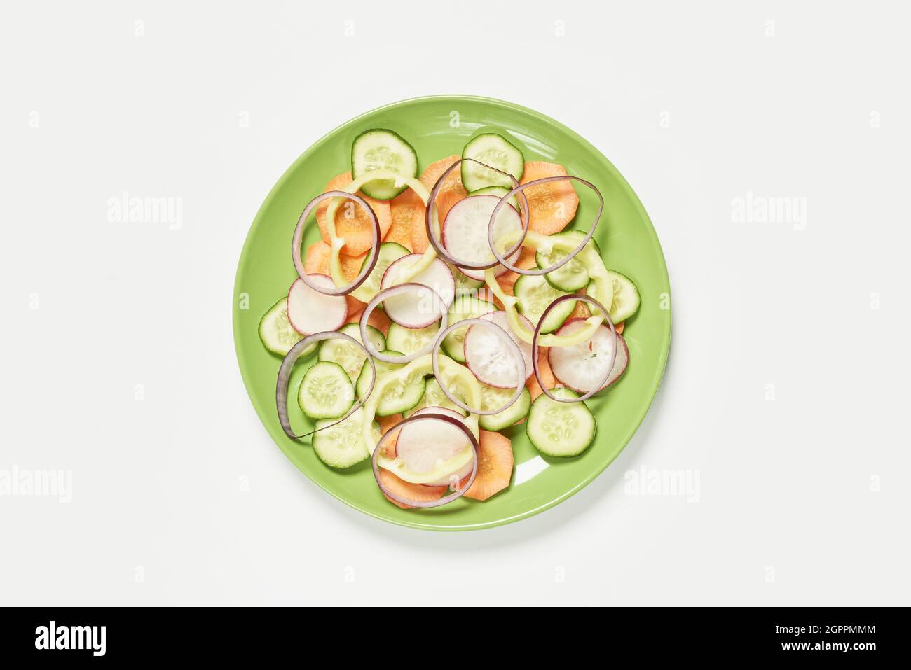 Top view of a plate with cut vegetables isolated on white background ...