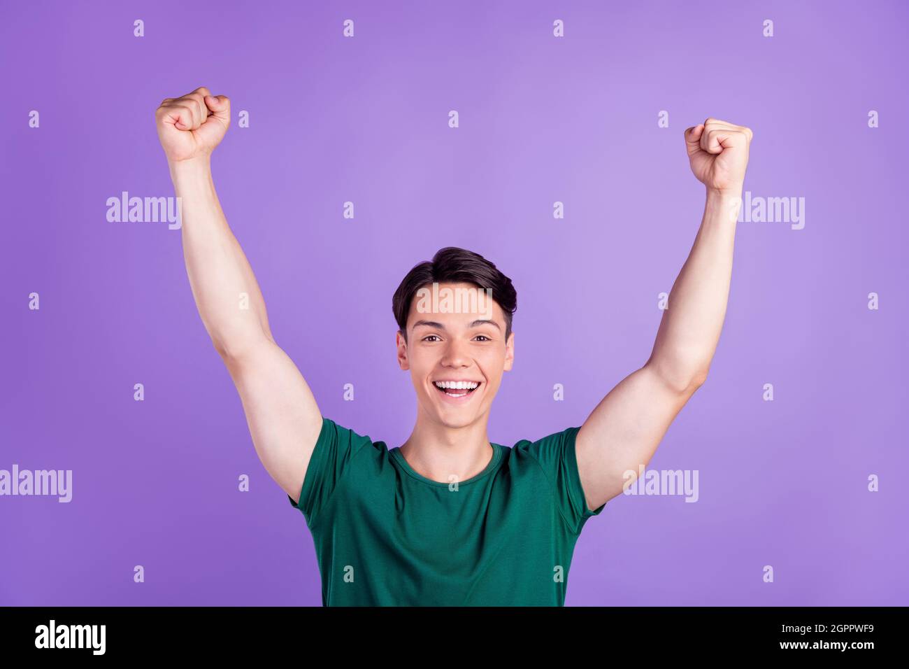 Photo of amazed positive cheerful man raise hands winner celebrate ...