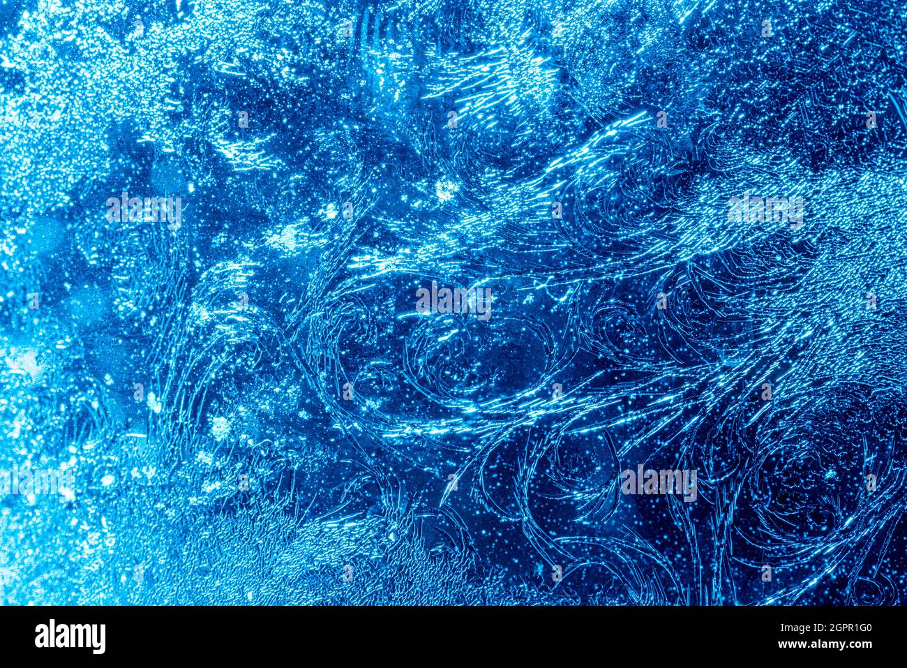 Beautiful blue frost patterns on frozen window as a symbol of Christmas ...