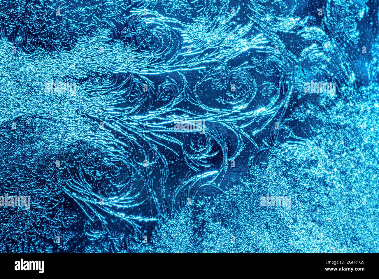 Beautiful blue frost patterns on frozen window as a symbol of Christmas ...