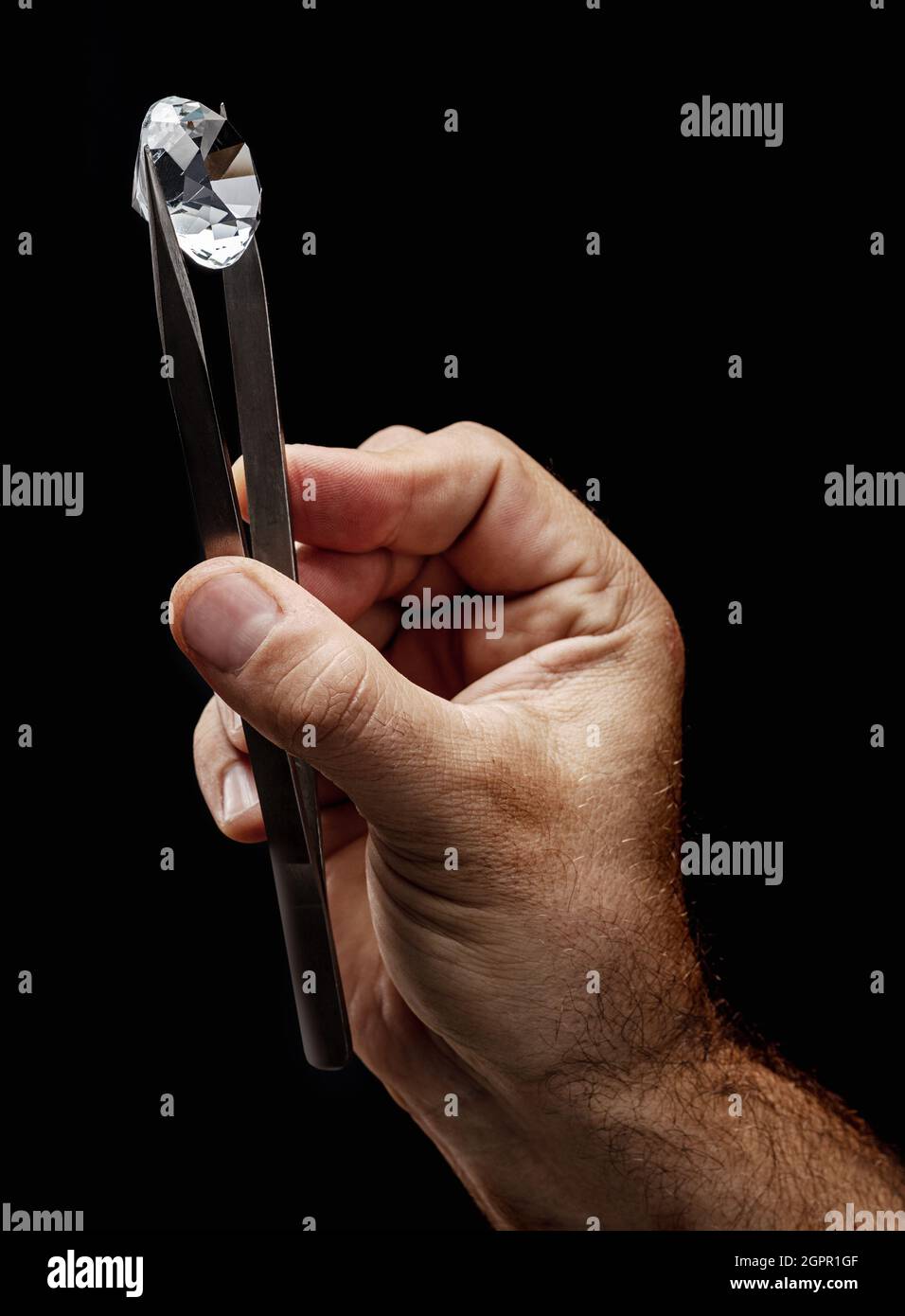 Large gemstone in jeweler's hand close up. Gem identifying and ...