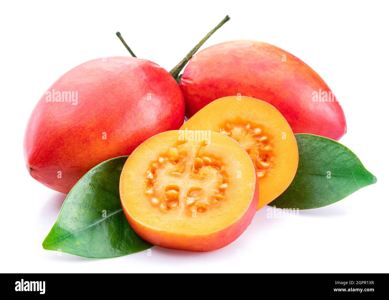 Ripe tamarillo fruits with slices and tamarillo leaves isolated on a ...