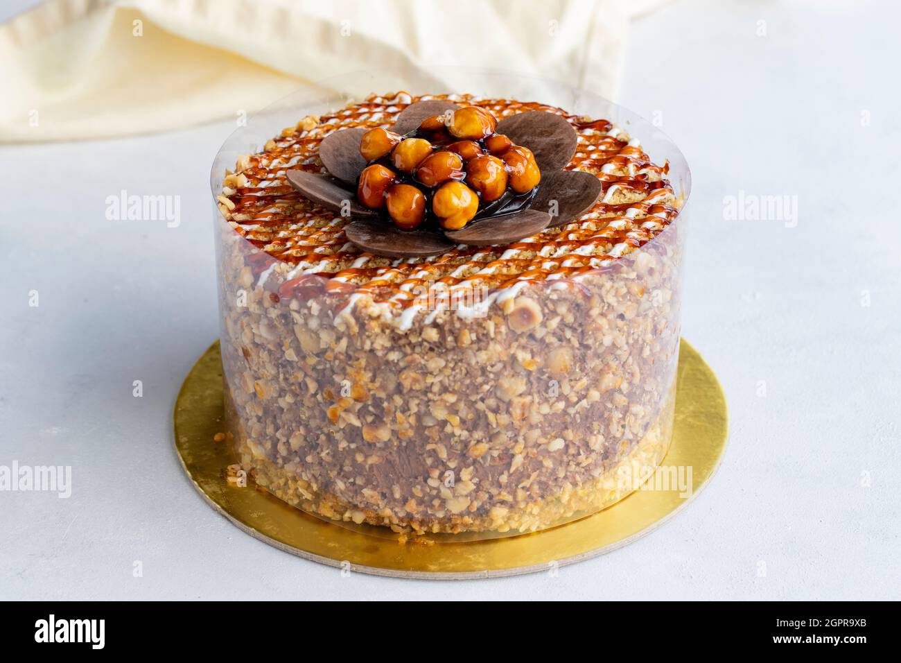 Chocolate cake with croquant on a white background Stock Photo - Alamy
