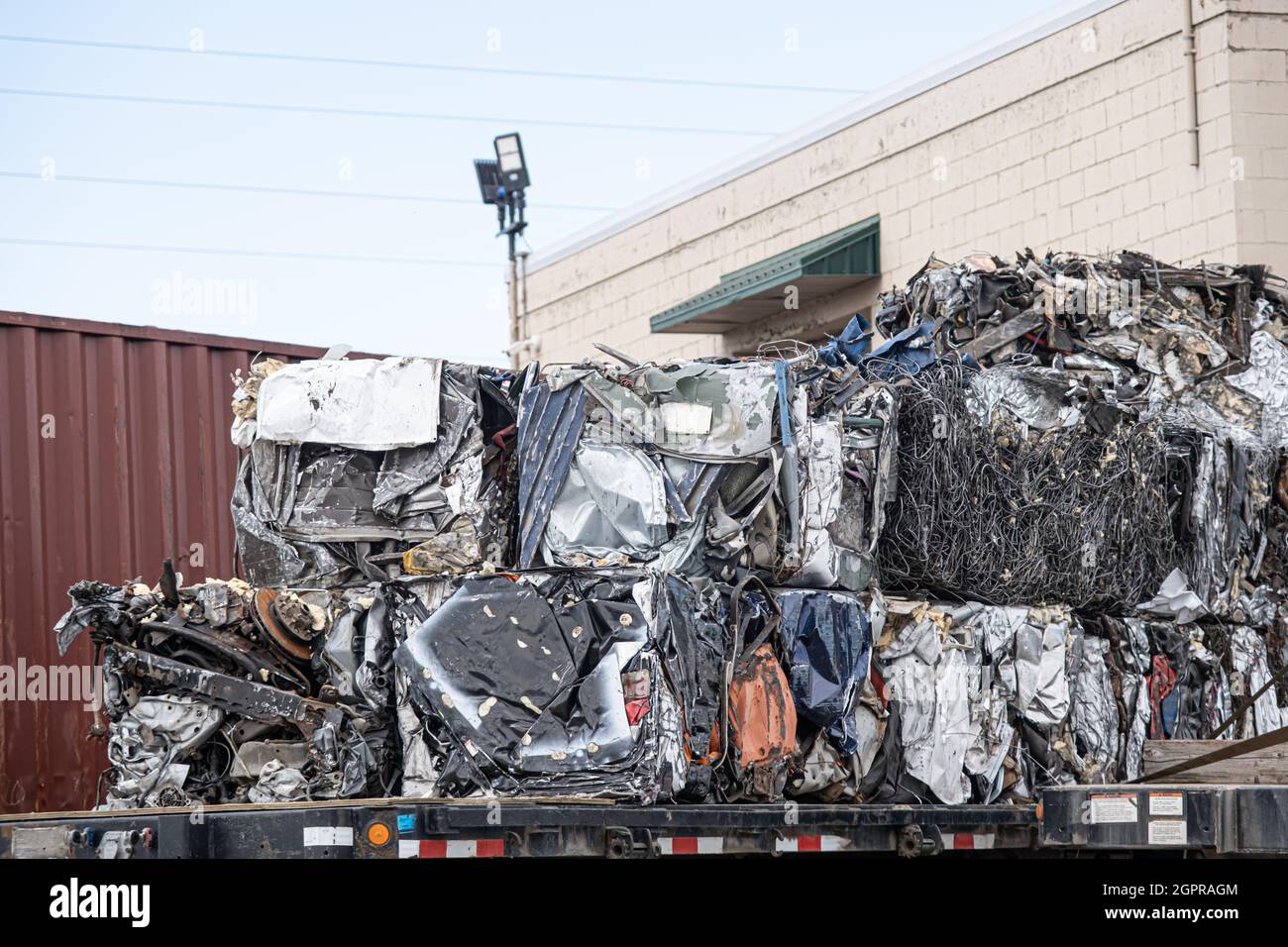 Compressed cubes of scrap metal at a junk yard Stock Photo - Alamy