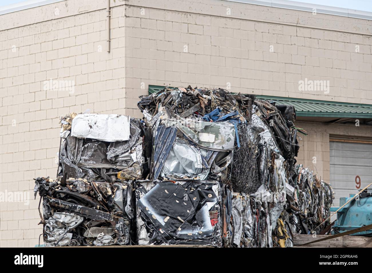 Compressed cubes of scrap metal at a junk yard Stock Photo - Alamy