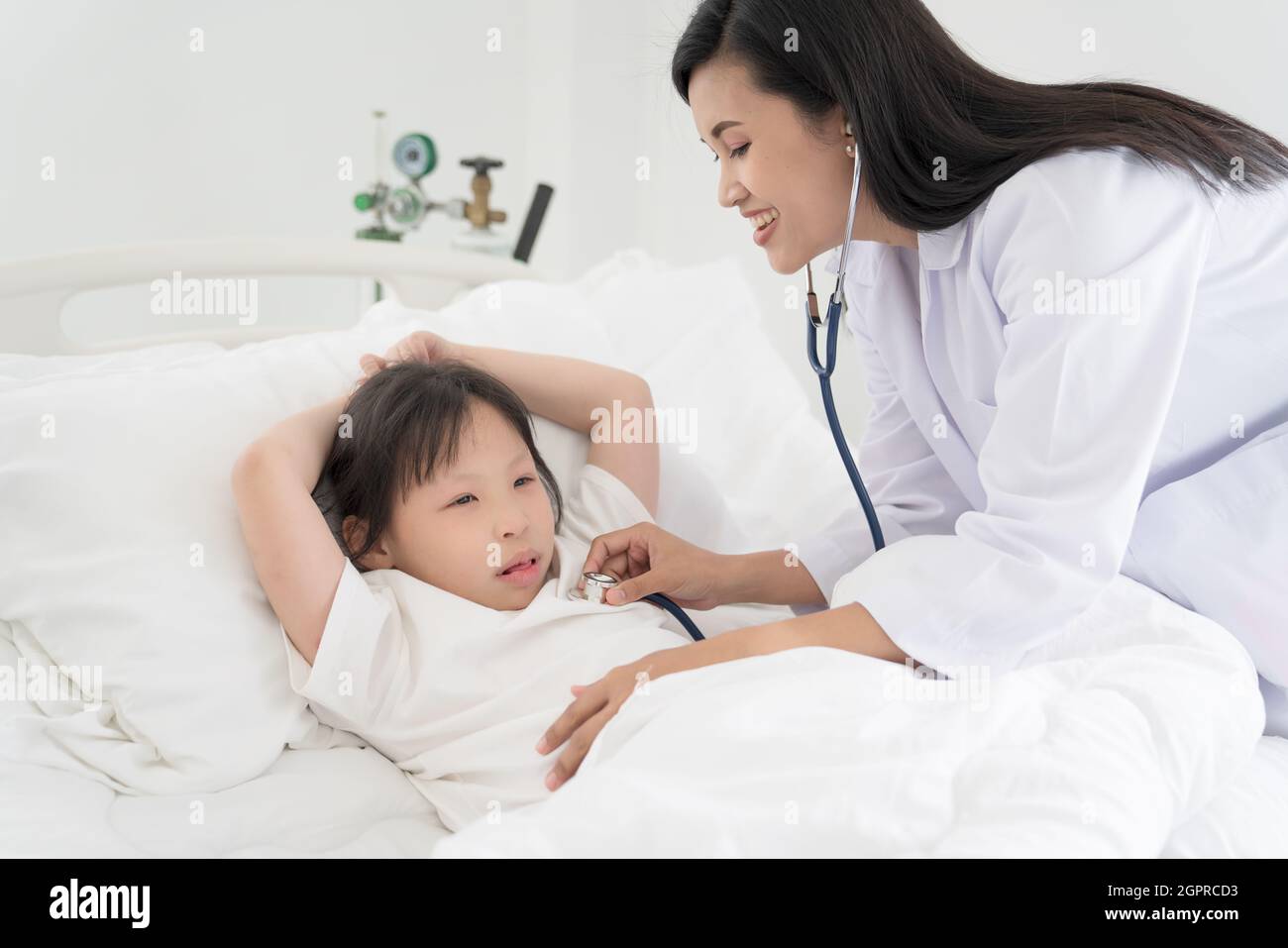 Doctor examining stomach girl hi-res stock photography and images - Alamy