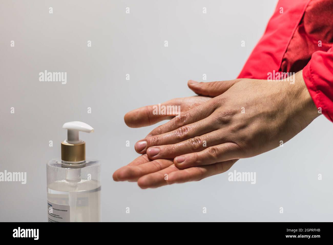Man sanitizing his hands Stock Photo - Alamy