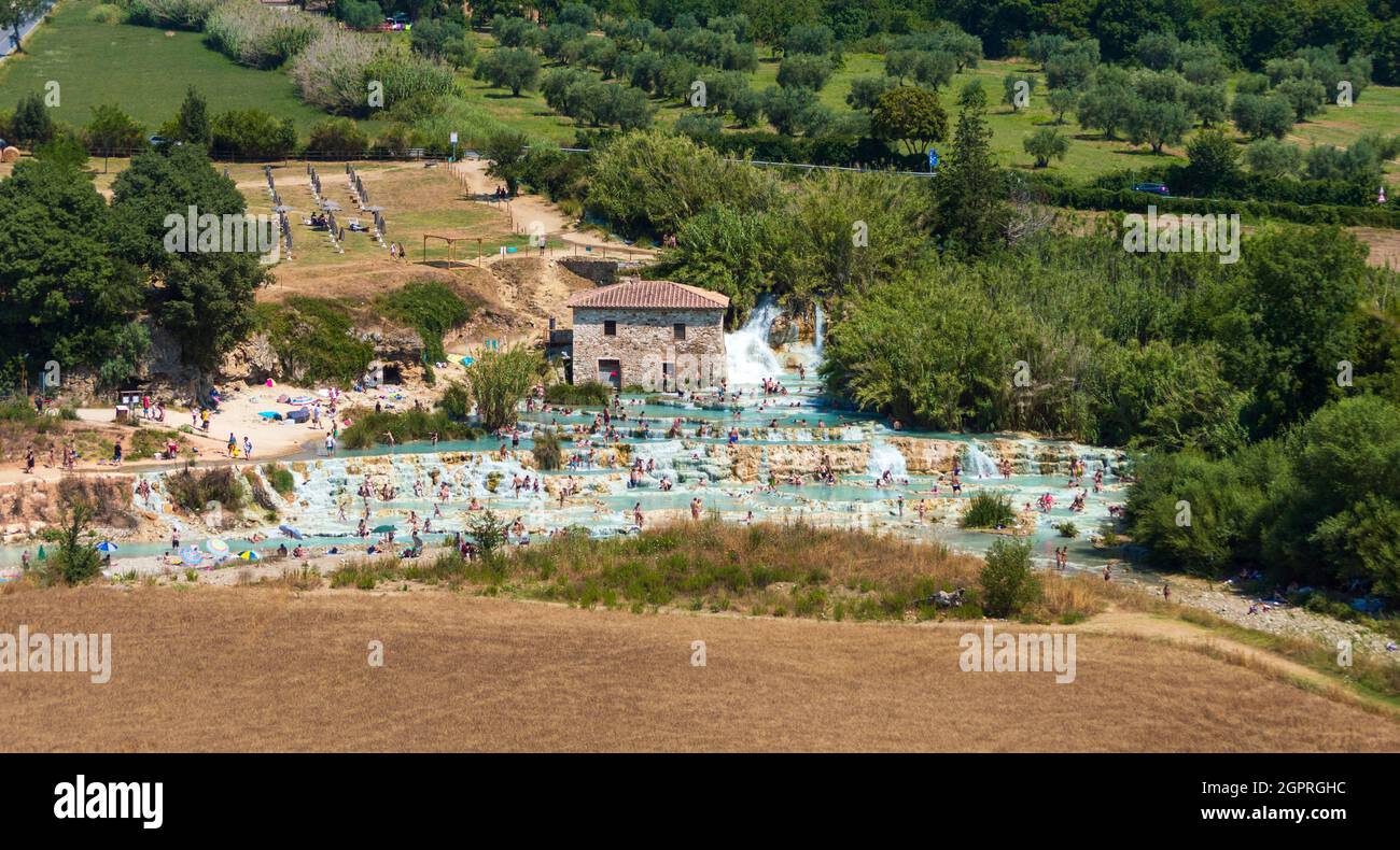 The gorgeous natural thermal bath of Saturnia. Warm water spills out of ...