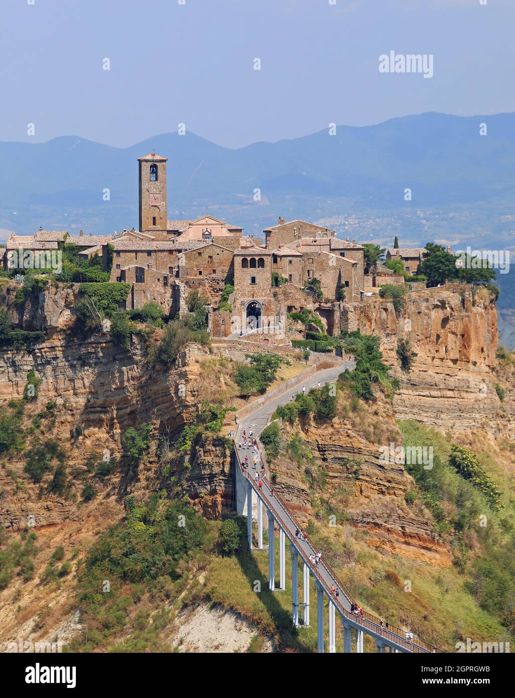 Village named Civita di Bagnoregio in central Italy and the long bridge ...