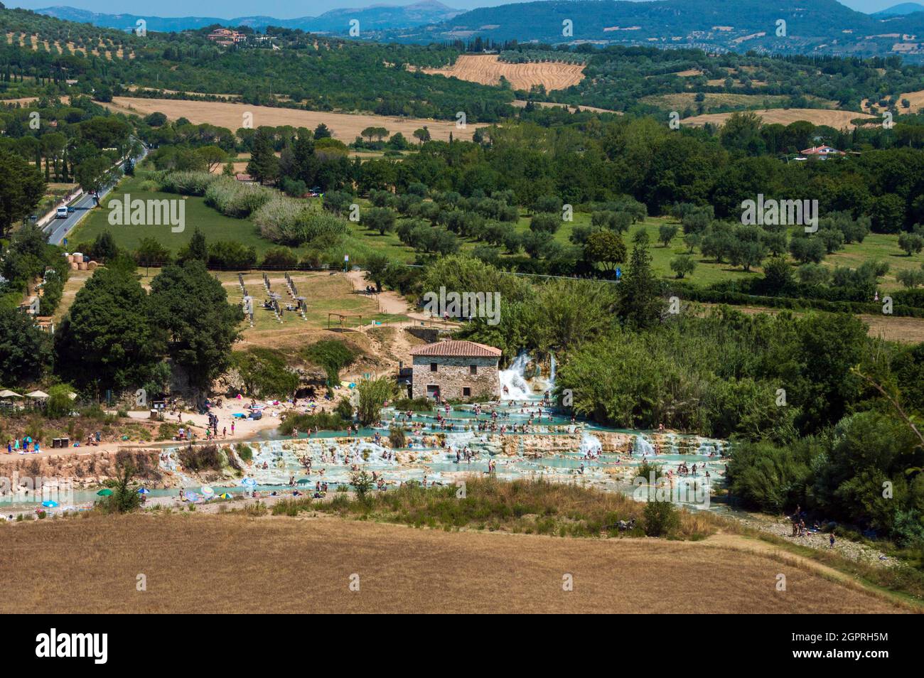 The gorgeous natural thermal bath of Saturnia. Warm water spills out of ...