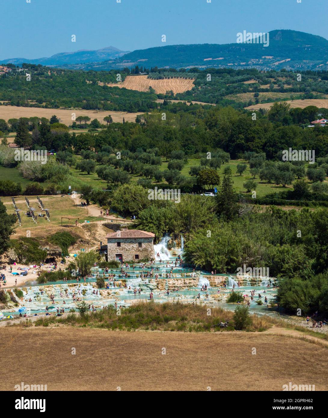 The gorgeous natural thermal bath of Saturnia. Warm water spills out of ...