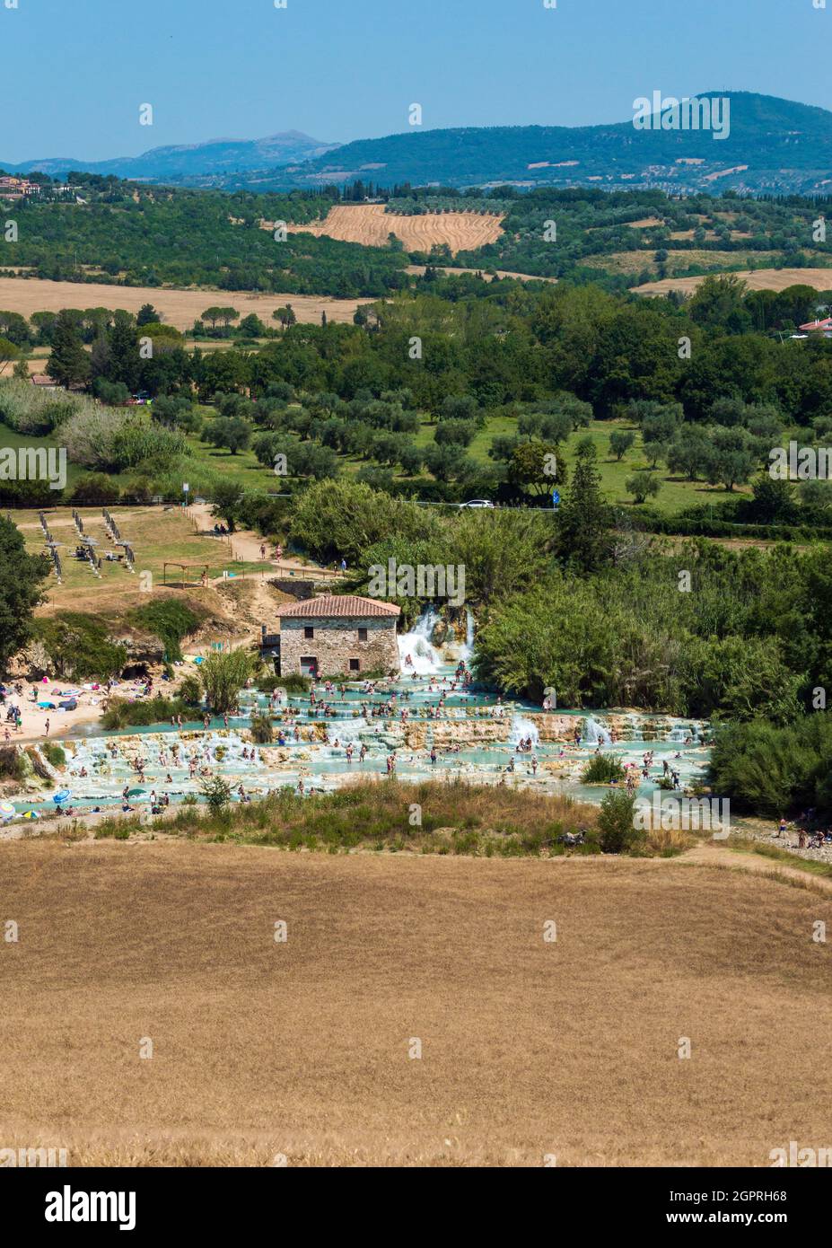 The gorgeous natural thermal bath of Saturnia. Warm water spills out of ...