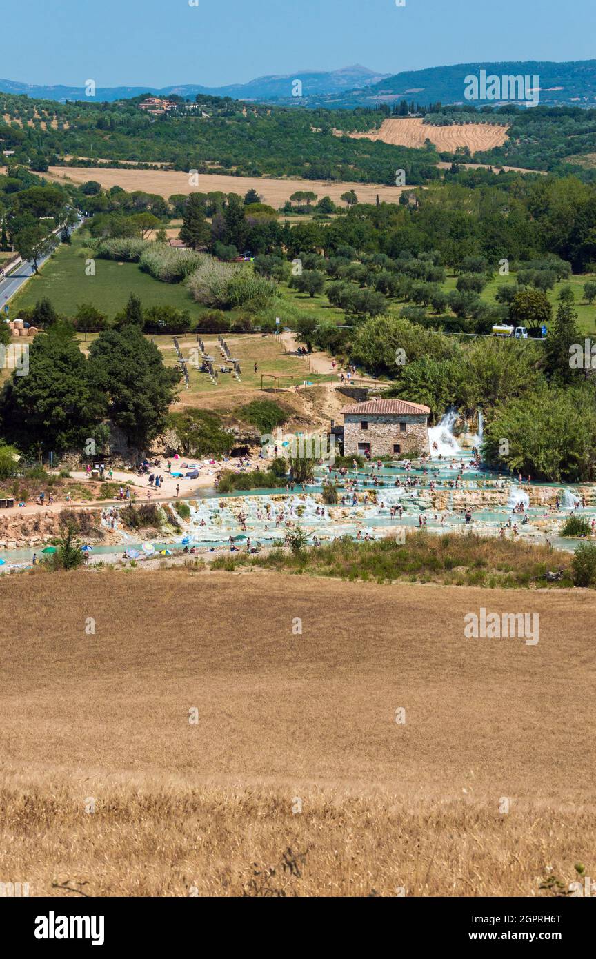 The gorgeous natural thermal bath of Saturnia. Warm water spills out of ...