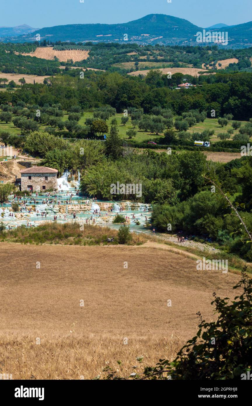 The gorgeous natural thermal bath of Saturnia. Warm water spills out of ...