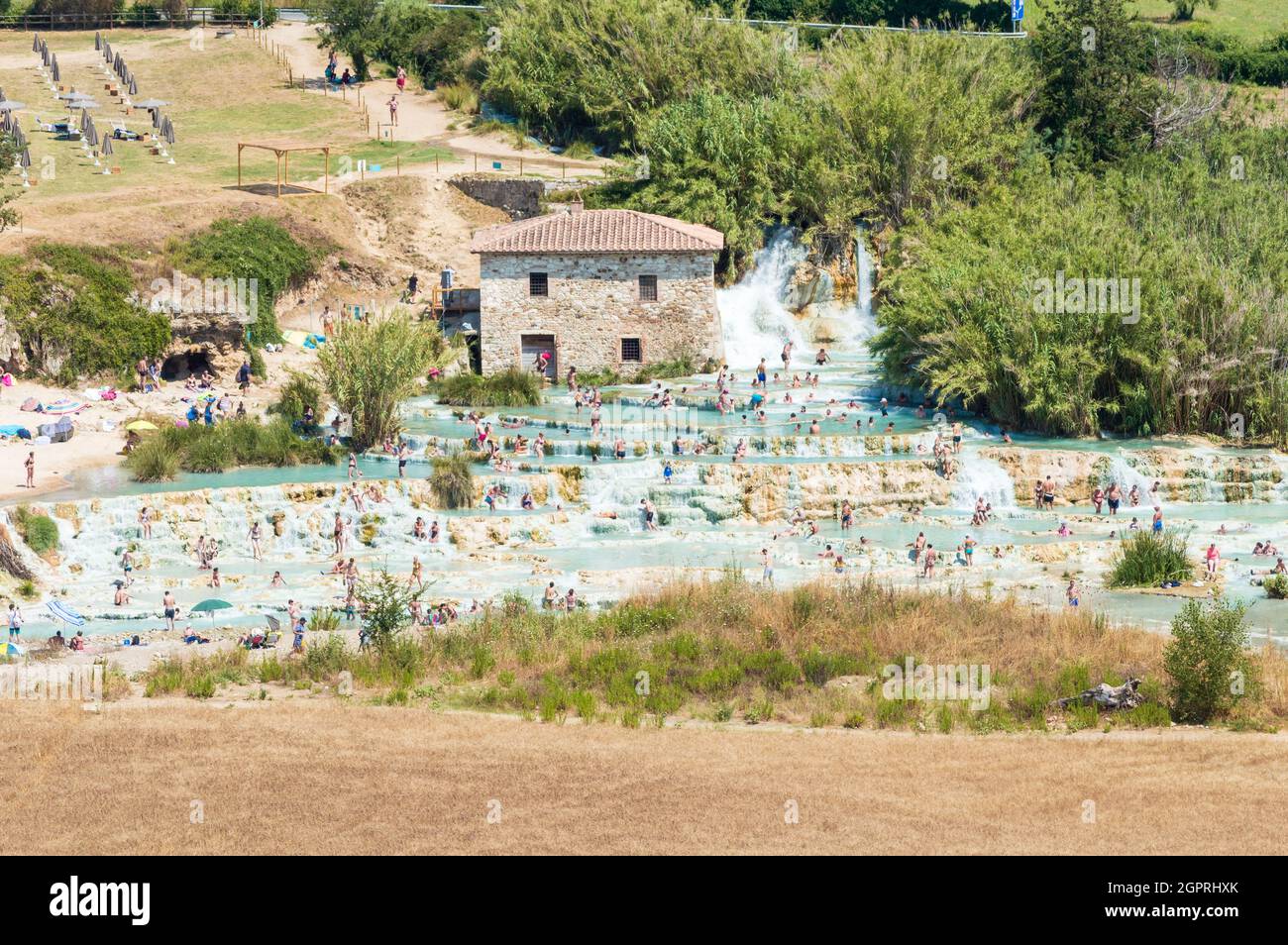 The gorgeous natural thermal bath of Saturnia. Warm water spills out of ...