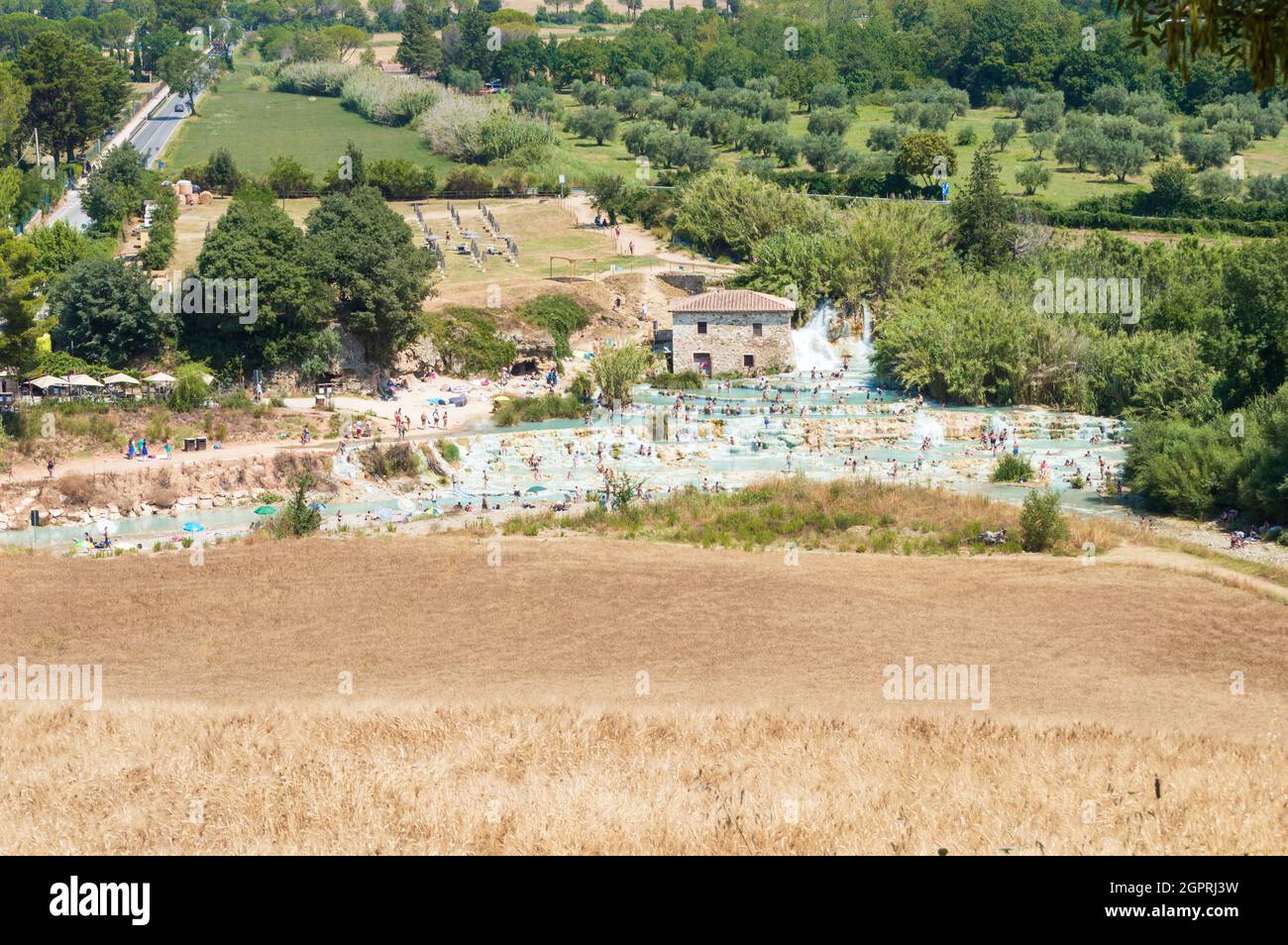 The gorgeous natural thermal bath of Saturnia. Warm water spills out of ...