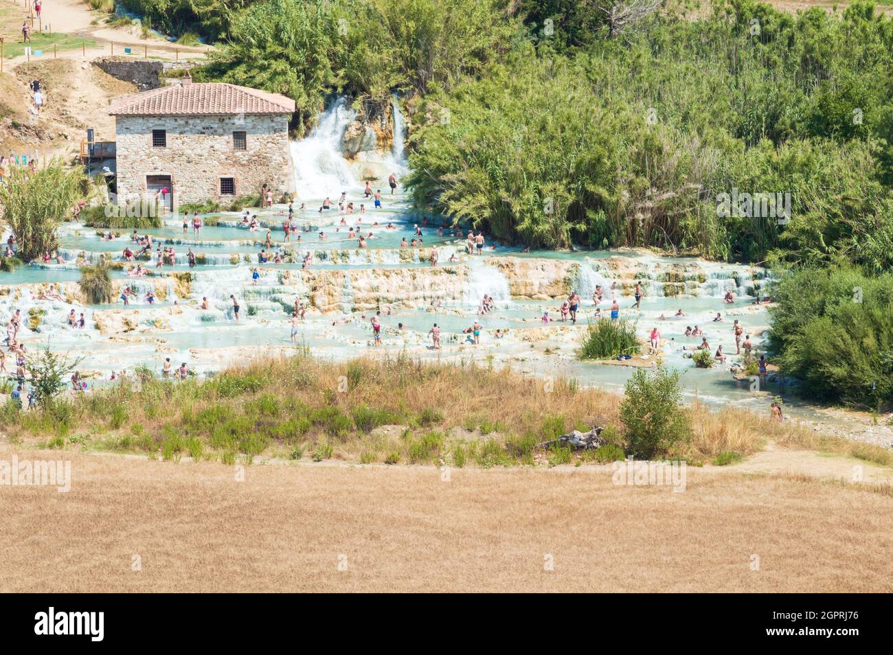 The gorgeous natural thermal bath of Saturnia. Warm water spills out of ...