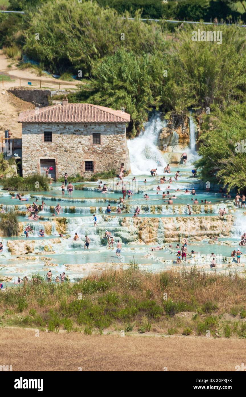 The gorgeous natural thermal bath of Saturnia. Warm water spills out of ...