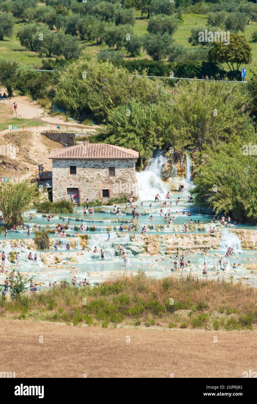 The gorgeous natural thermal bath of Saturnia. Warm water spills out of ...