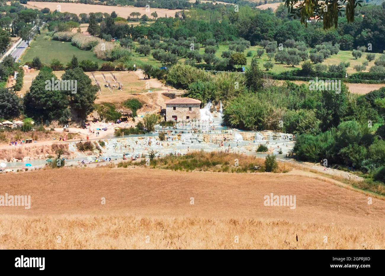 The gorgeous natural thermal bath of Saturnia. Warm water spills out of ...