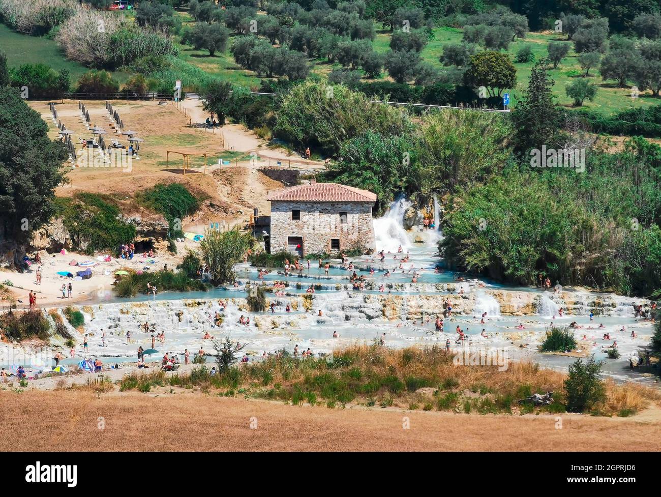 The gorgeous natural thermal bath of Saturnia. Warm water spills out of ...