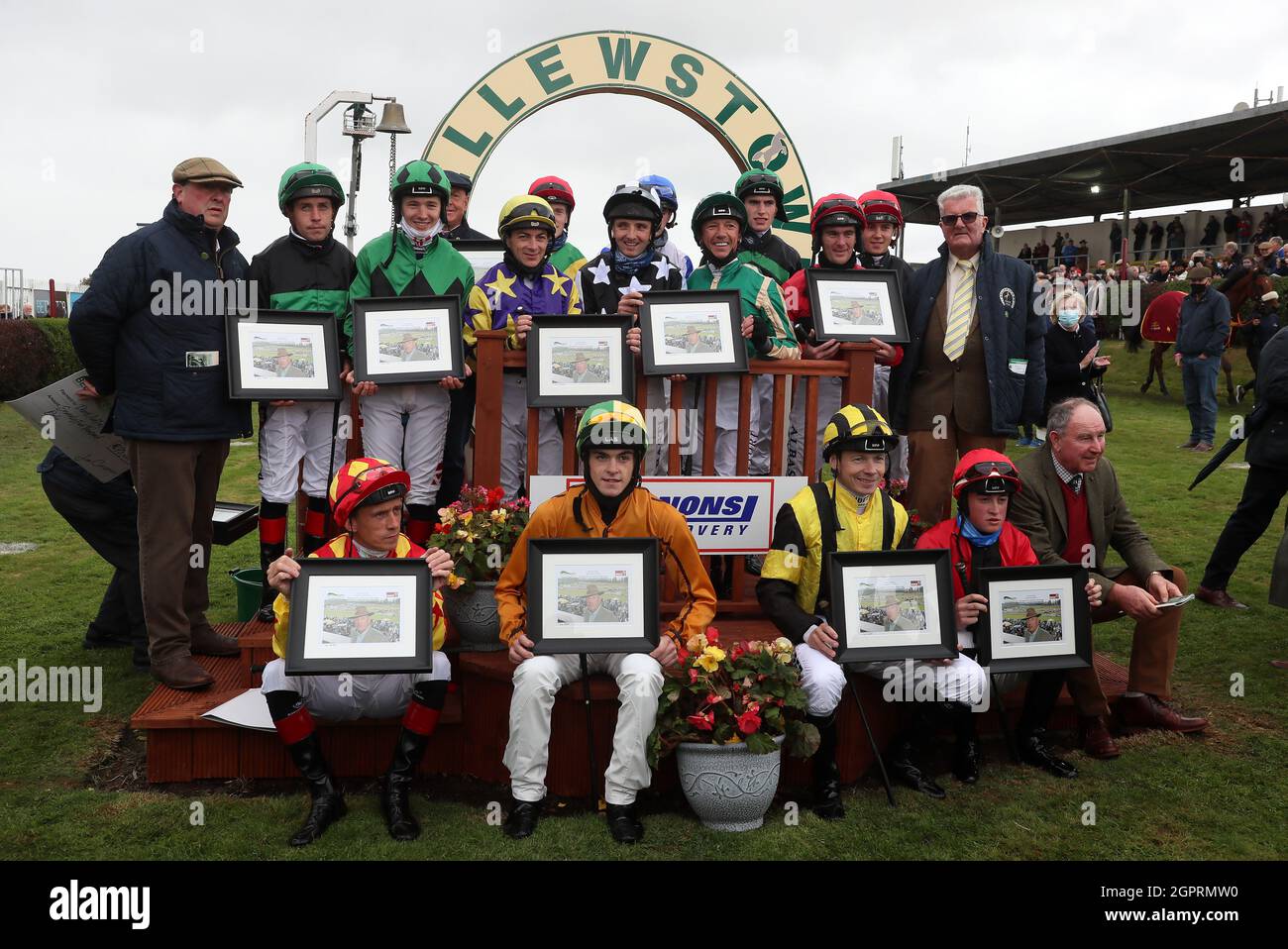Jockeys in the parade ring with a tribute to Barney Curley at ...