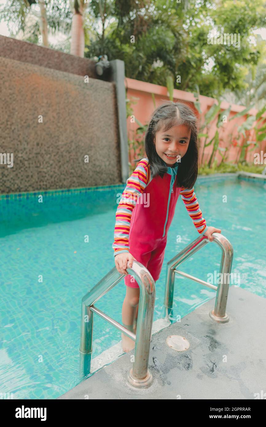 Kids sitting poolside hi-res stock photography and images - Alamy