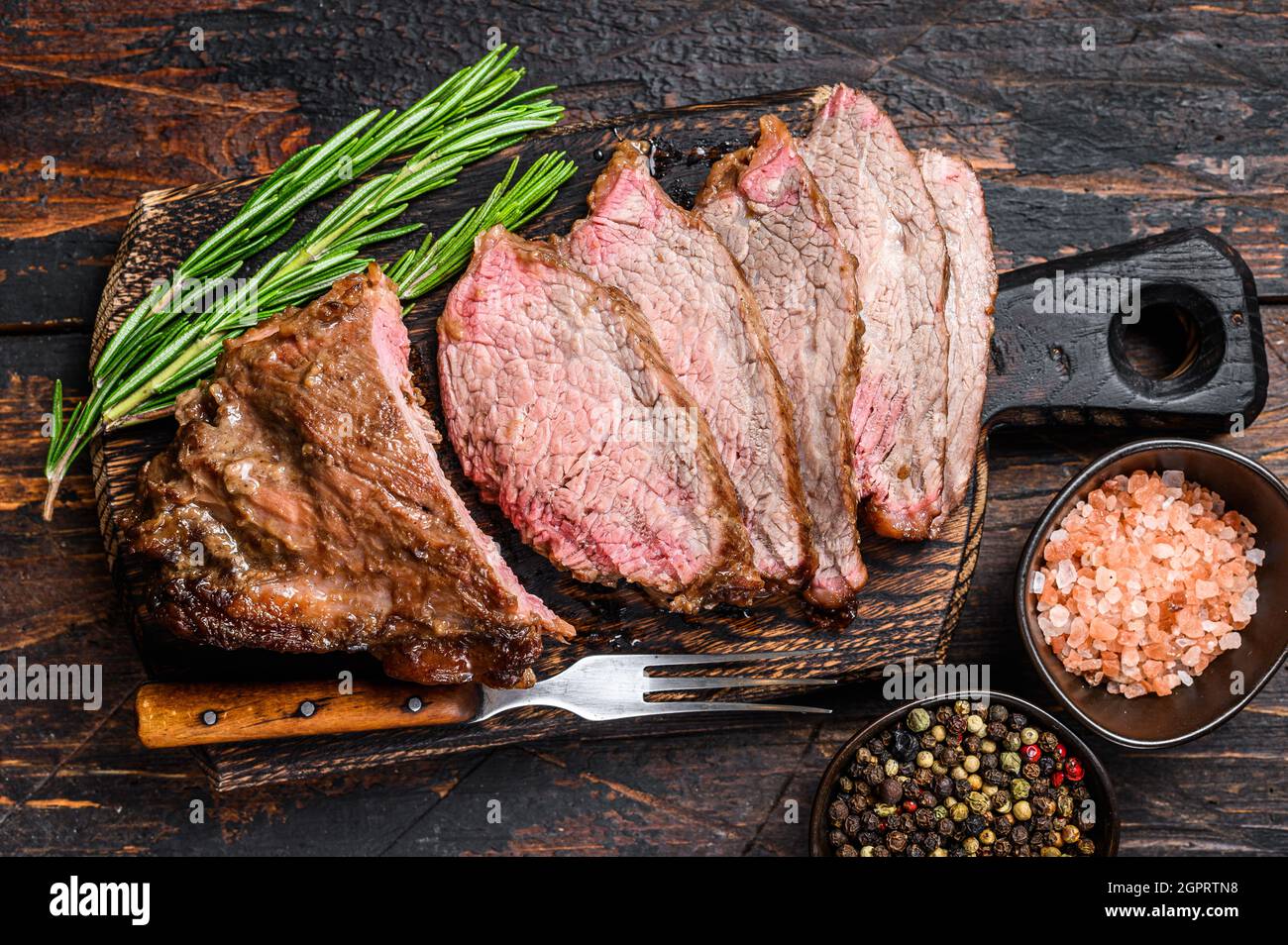 Sliced Roast beef sirloin tri tip steak bbq. Dark wooden background ...