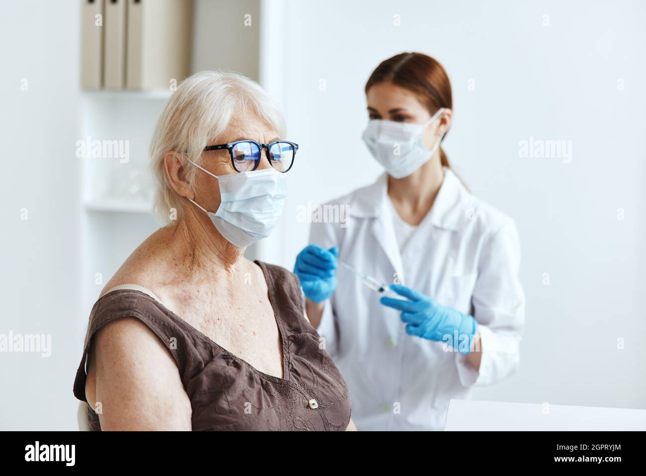 medical mask nurse makes an injection in the arm immunization safety ...