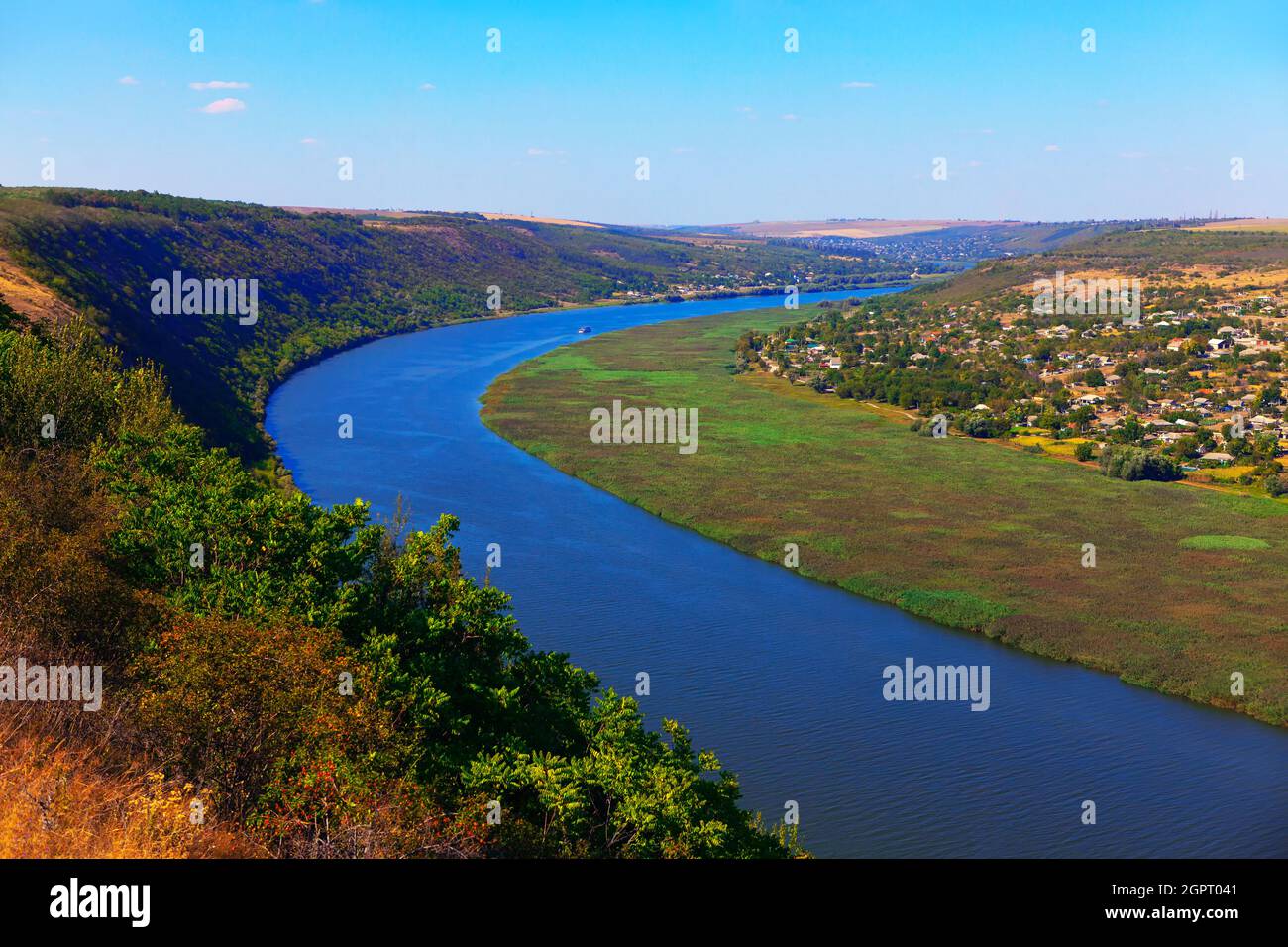 Idyllic scenery with river . Village situated on the riverside . River ...