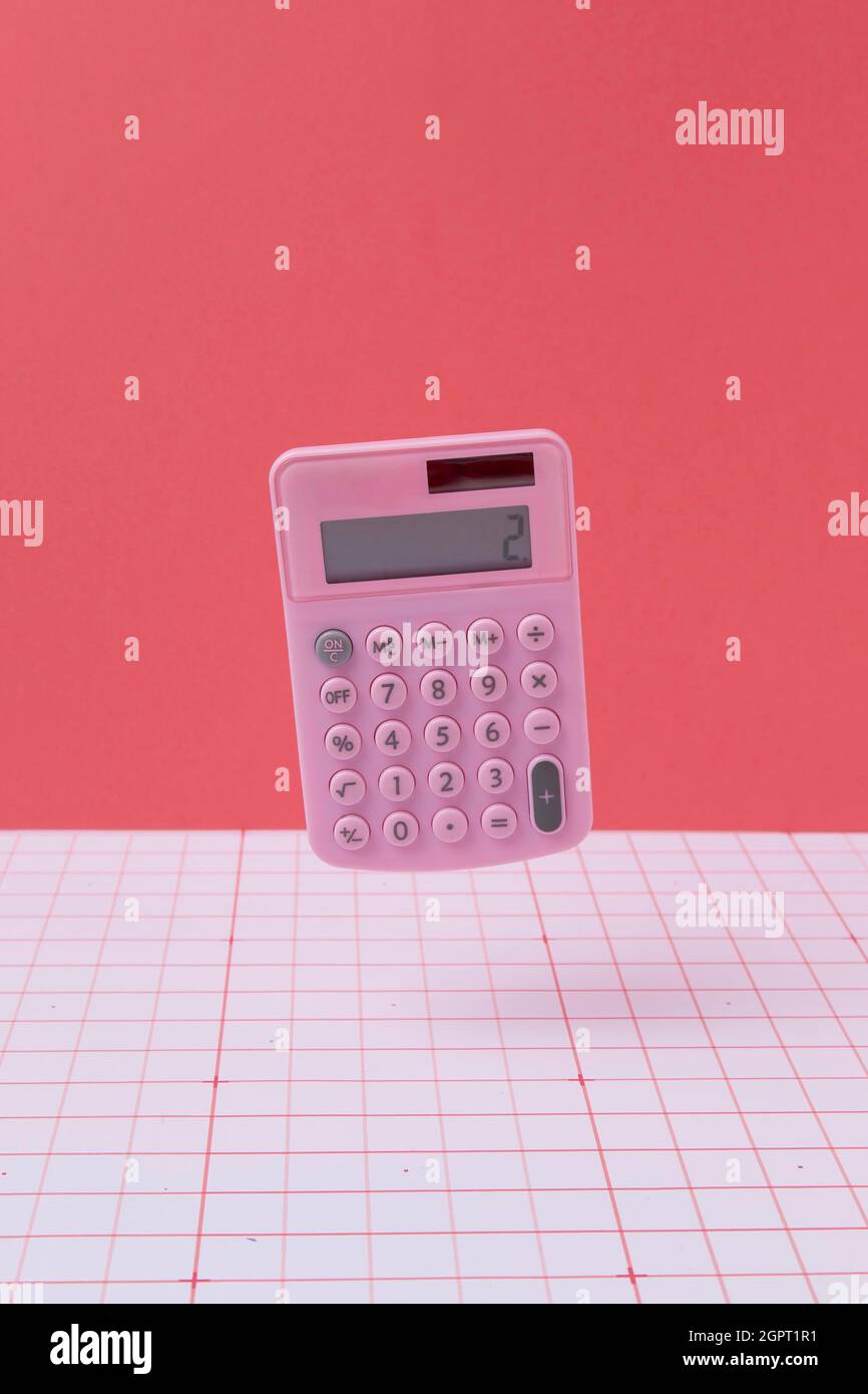 Math arrangement with calculator floating Stock Photo - Alamy