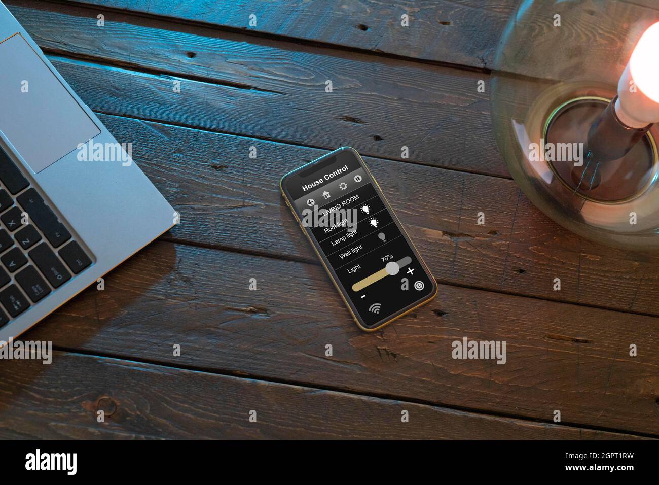 Man controlling smart lamp with his phone Stock Photo - Alamy