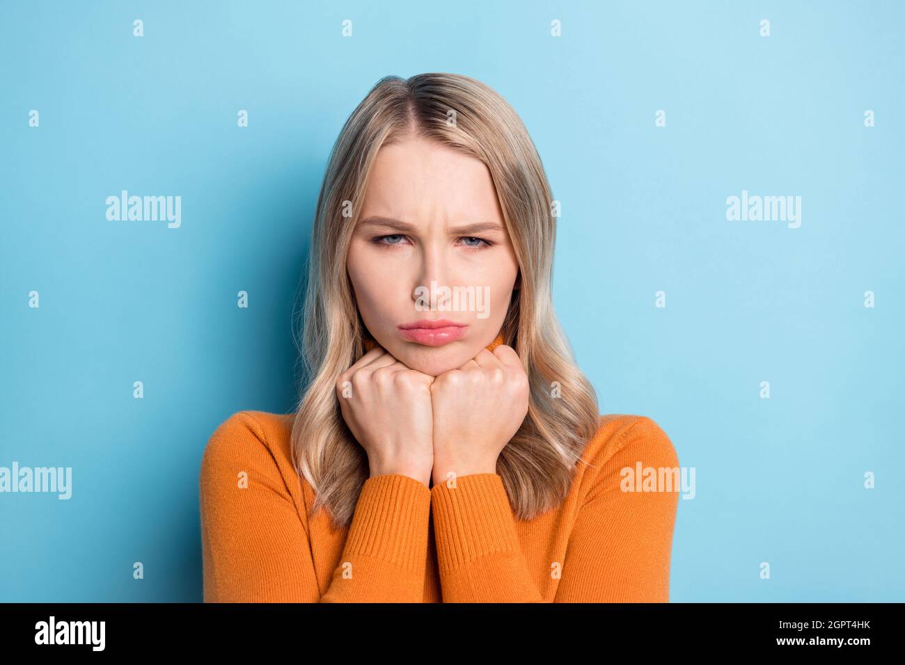 Photo of sad unhappy young lady wear orange sweater arms chin isolated ...