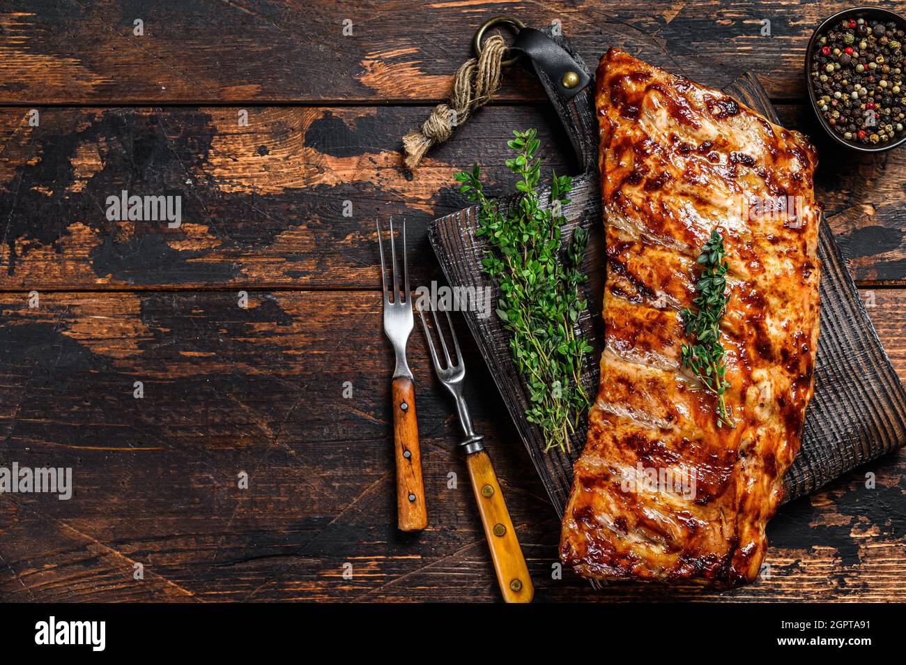 BBQ grilled pork spare ribs on a cutting board. Wooden background. Top ...