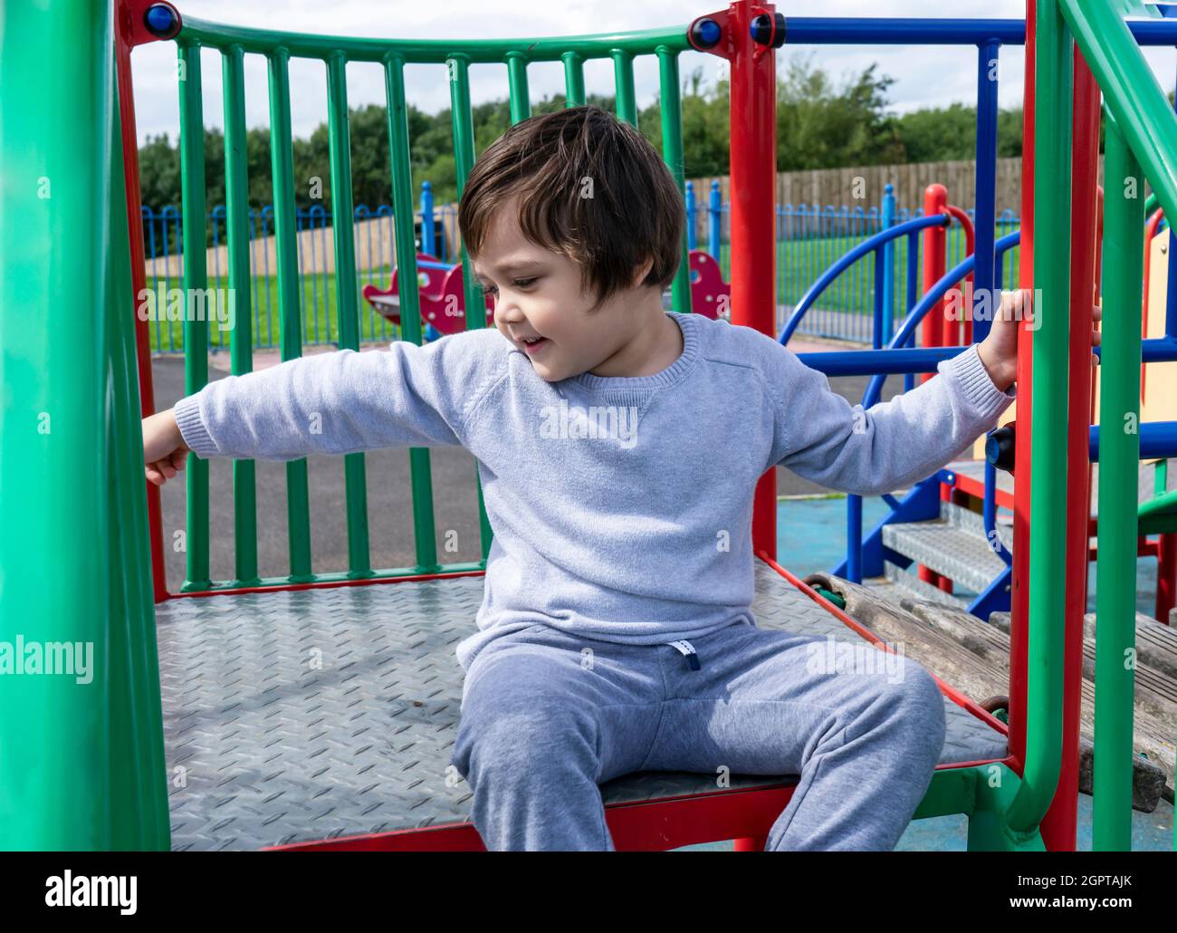 Playground slide man sitting hi-res stock photography and images - Alamy