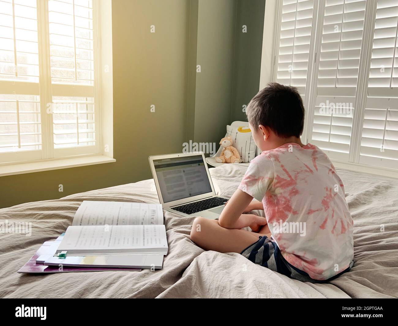 Boy does homework in bedroom hi-res stock photography and images - Alamy