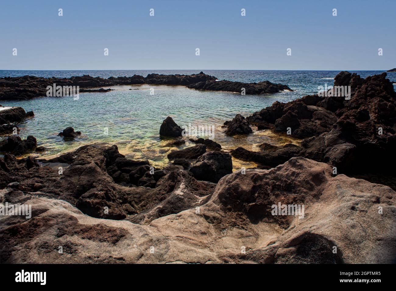 View of the scenic lava rock cliff in the Linosa island. Sicily Stock ...