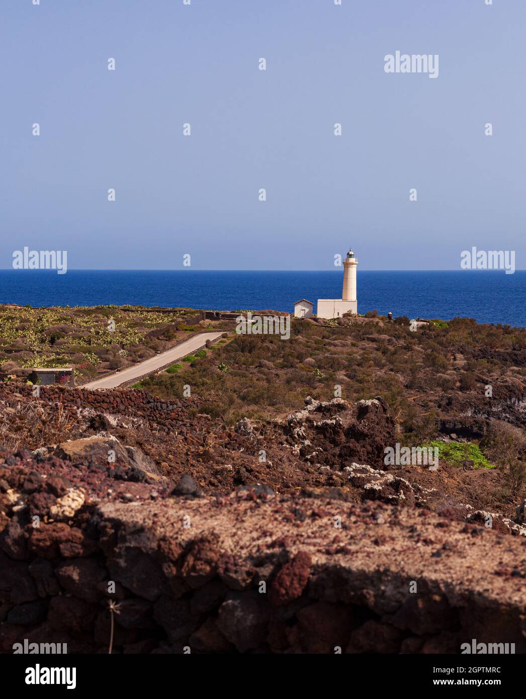 View of lighthouse in the scenic lava rock cliff, Linosa island. Sicily ...