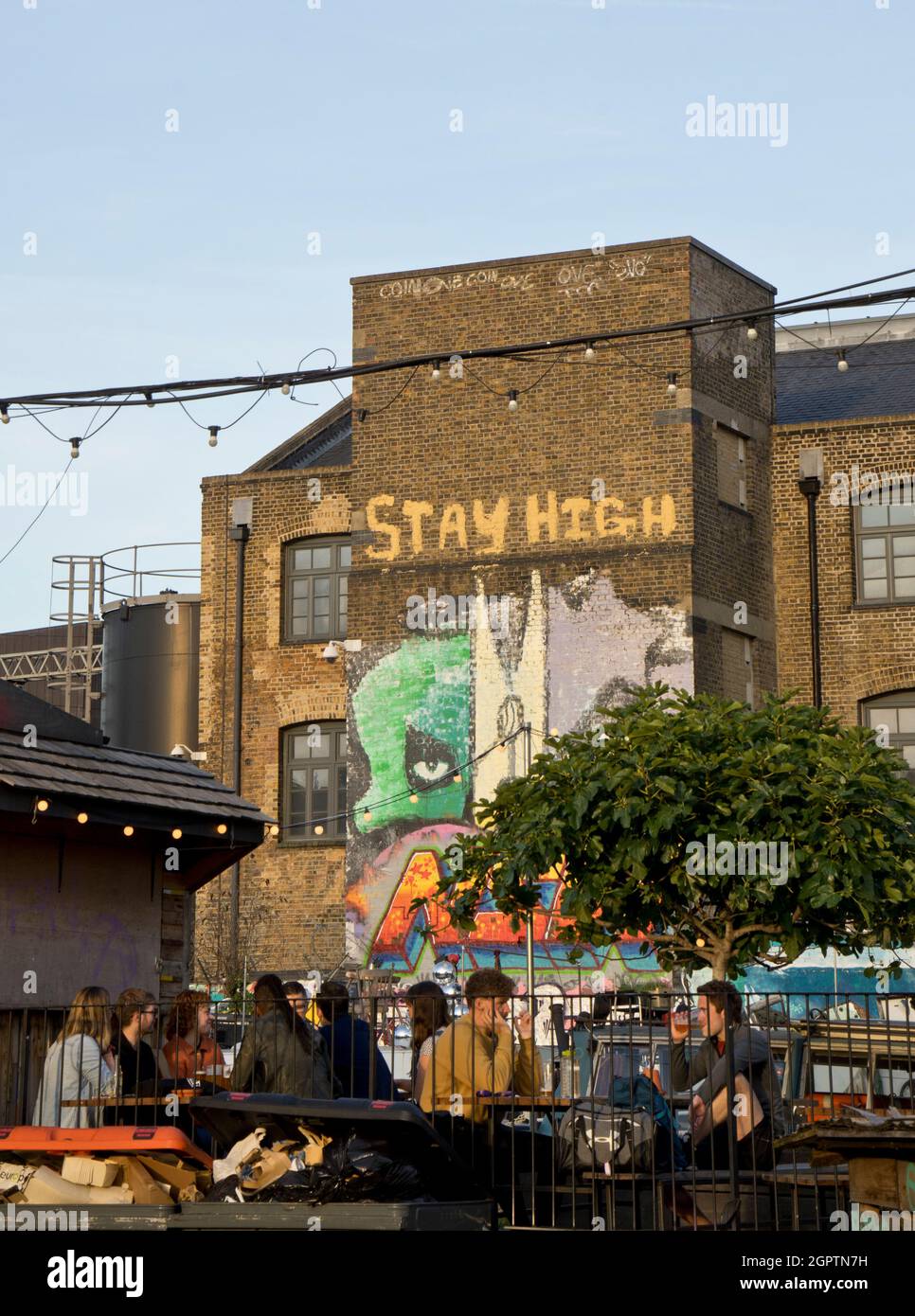 Old pub and warehouse studios by the Lea river canal with graffiti art ...